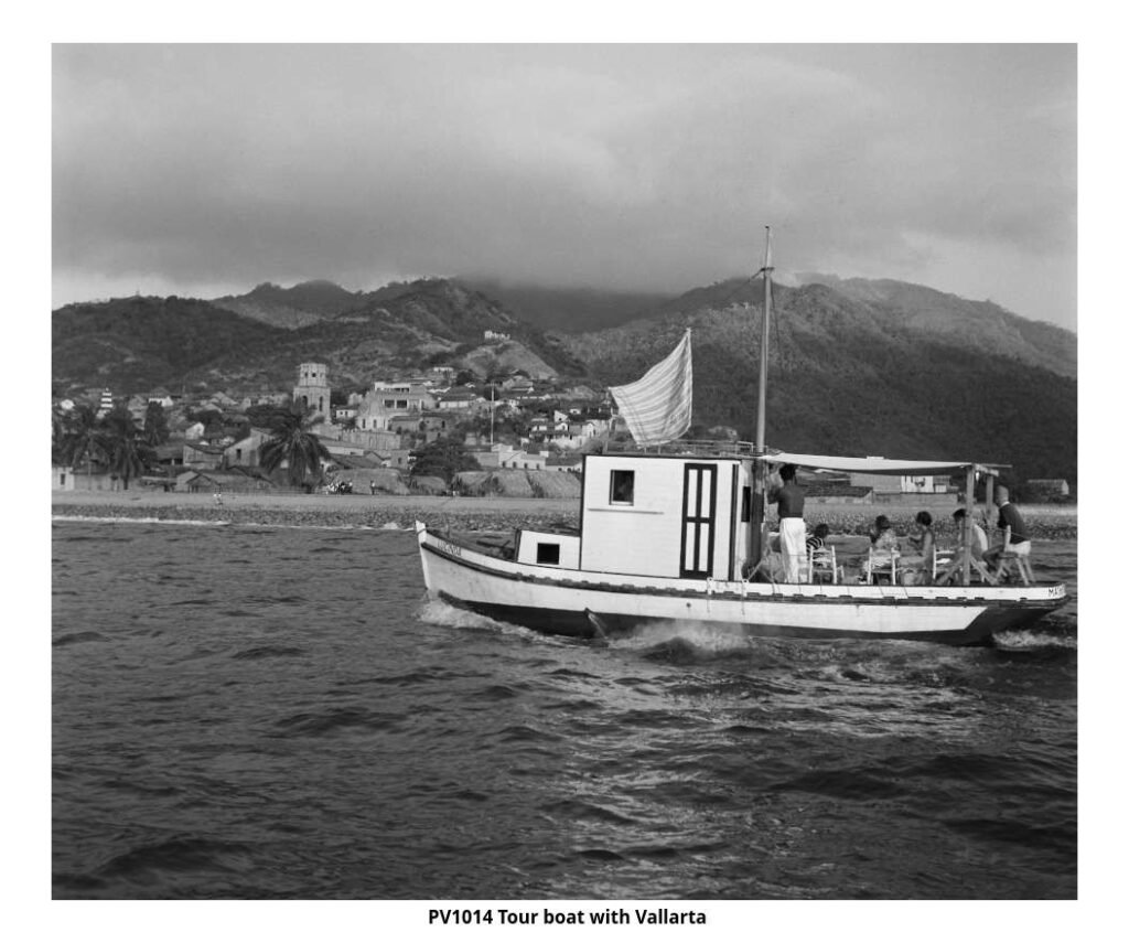 Boat on the ocean with Puerto Vallarta behind. – Harry Rowed Photography